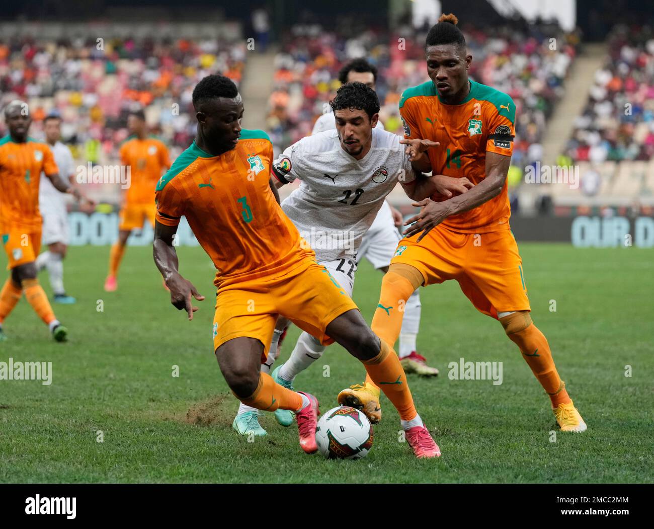 Egypt's Omar Marmoush, is challenged by Ivory Coast's Ghislain Konan ...
