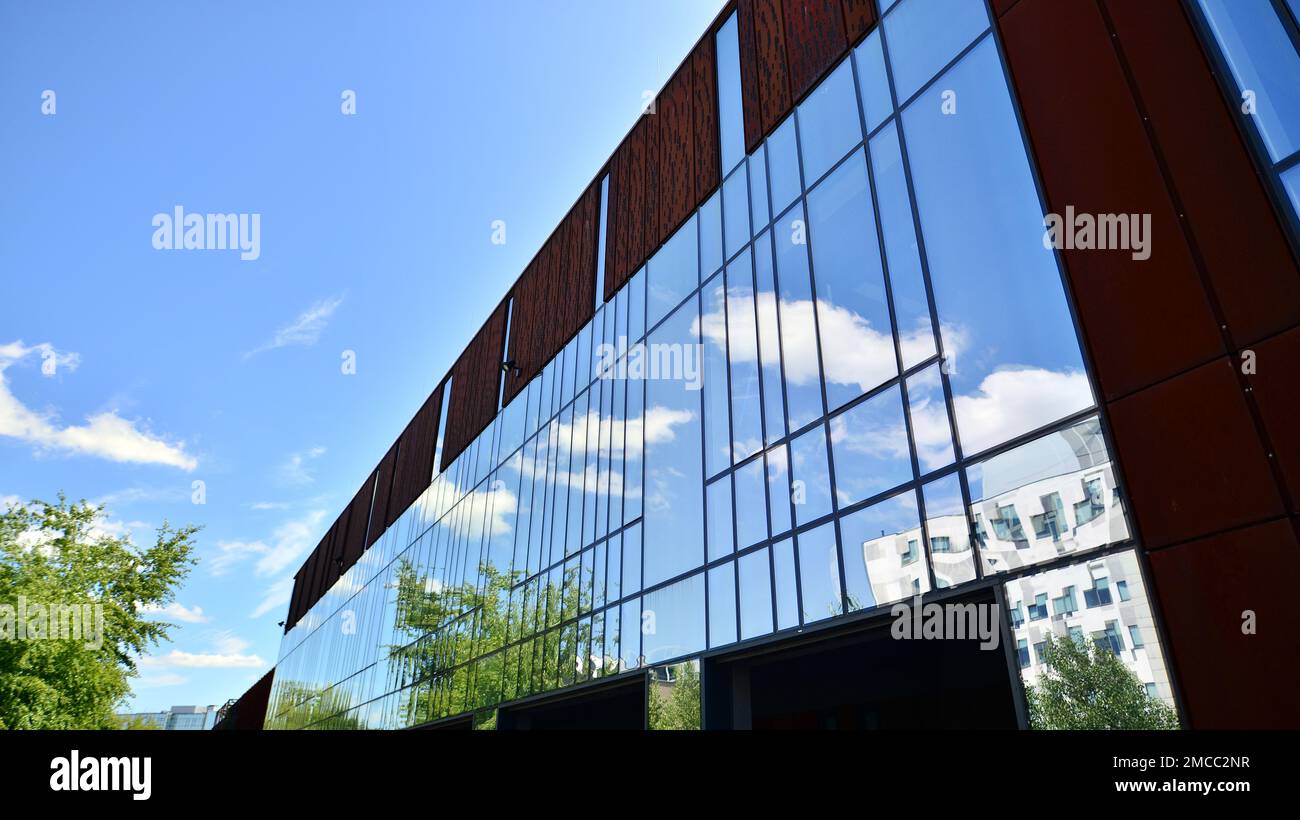 Architecture details. Modern glass building facade in sunny day ...