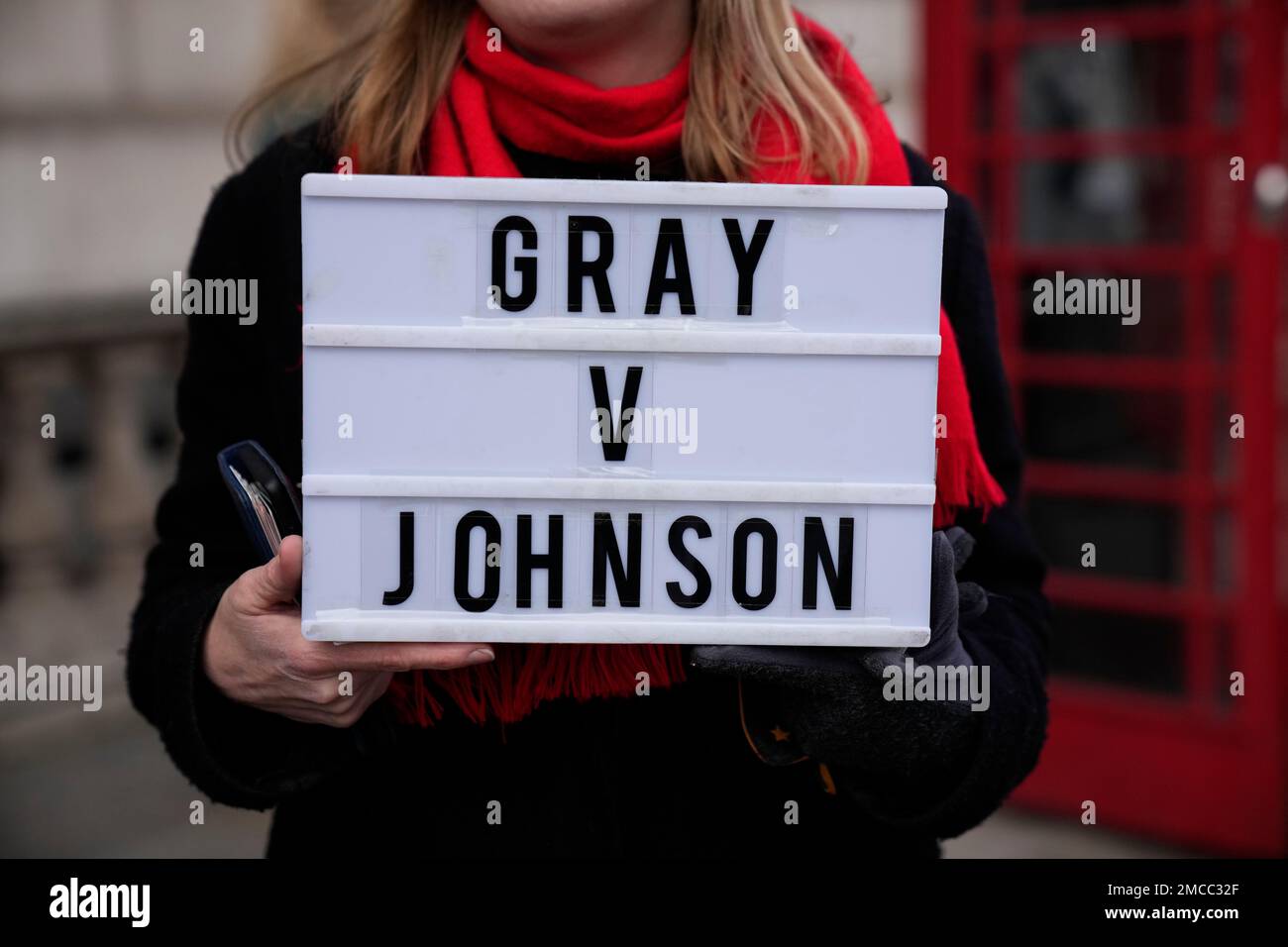 An anti-Boris Johnson protester holds a placard as a reference to the ...