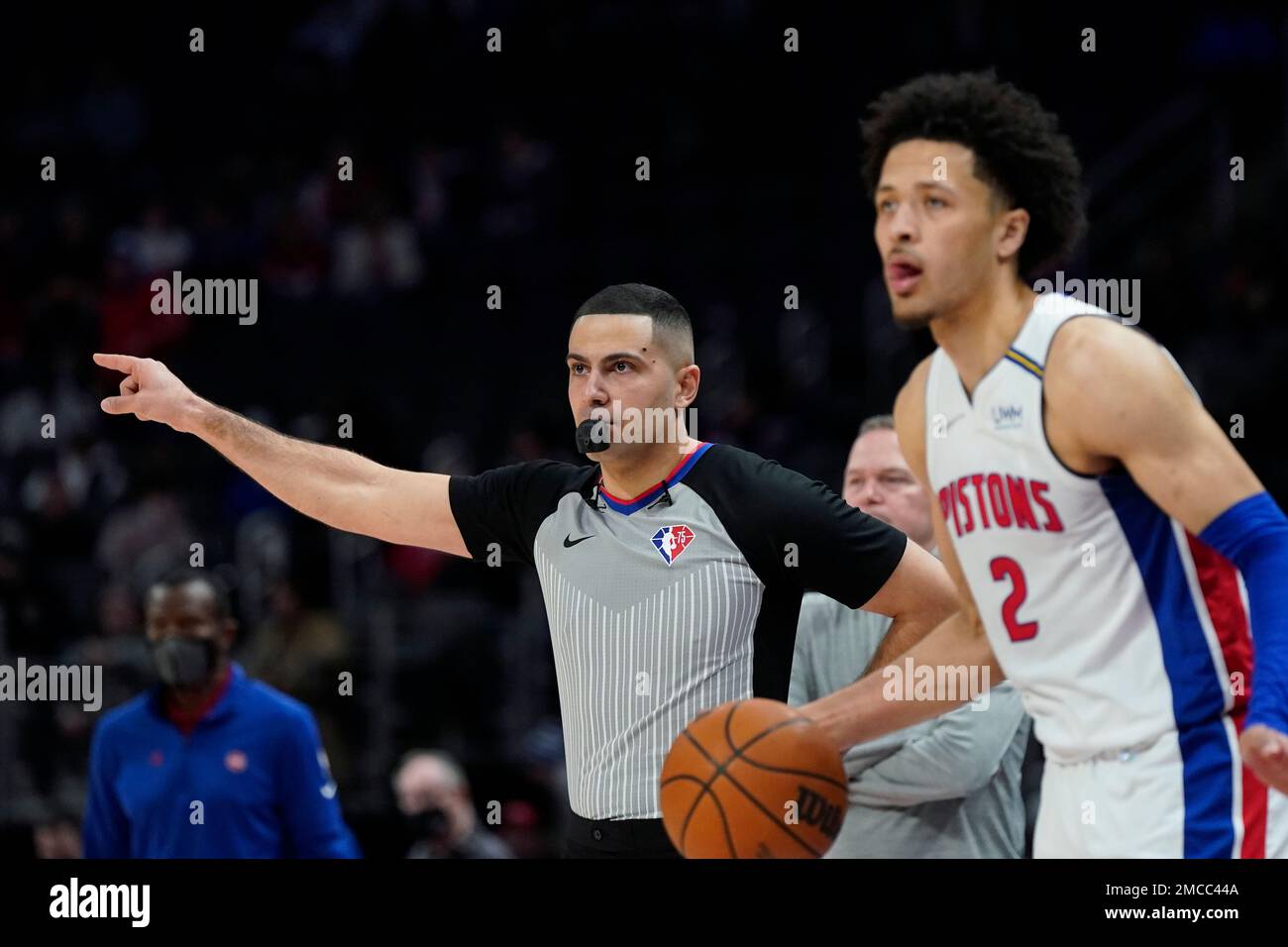 Referee Mousa Dagher signals as Detroit Pistons guard Cade Cunningham ...