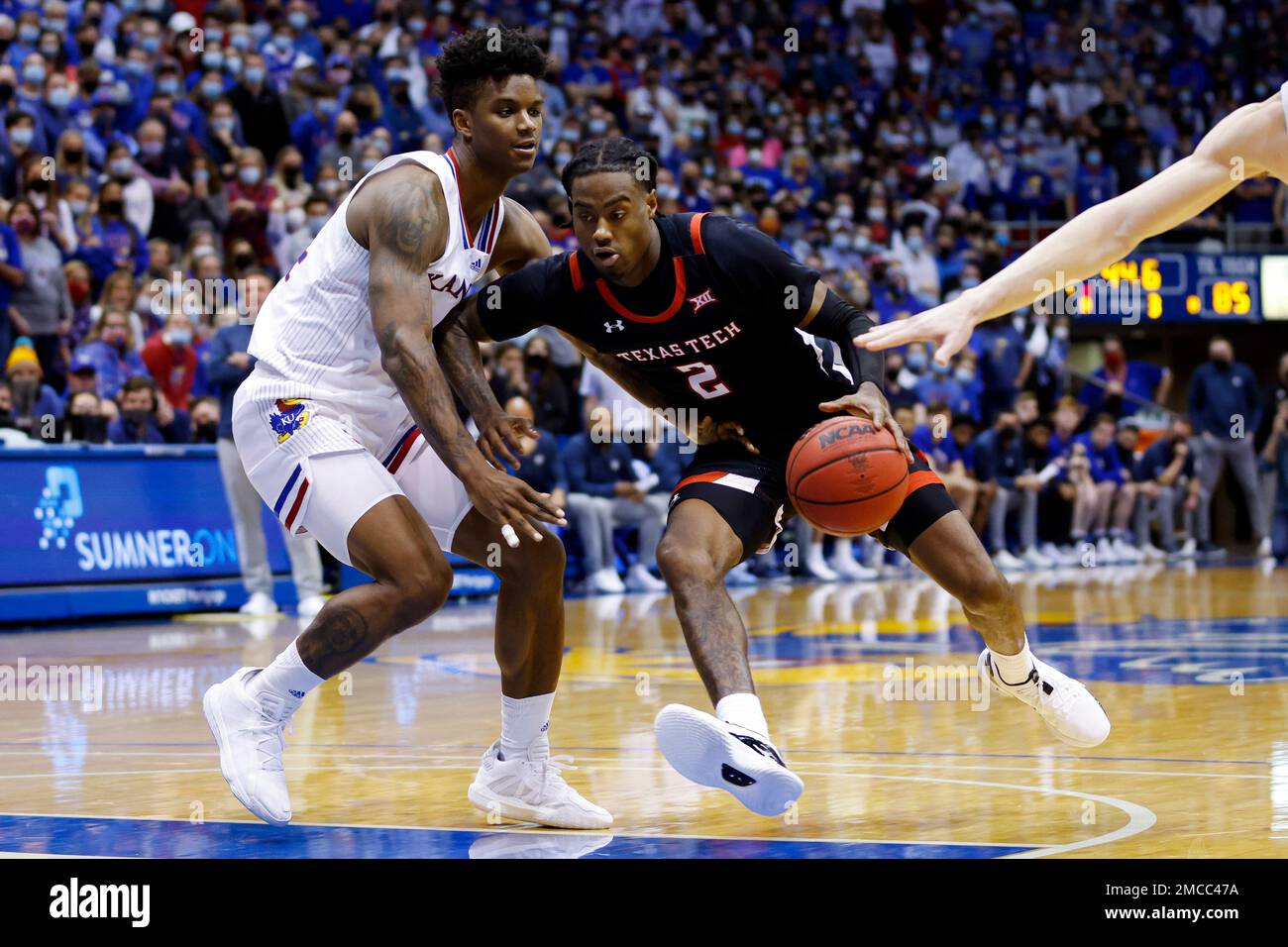 Texas Tech guard Davion Warren (2) attempts to get past Kansas forward ...