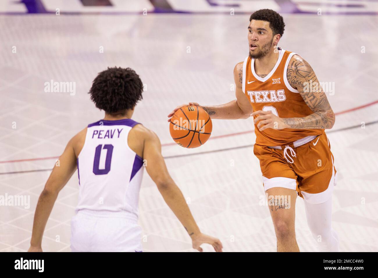 Texas forward Timmy Allen, right, dribbles down the court against TCU ...