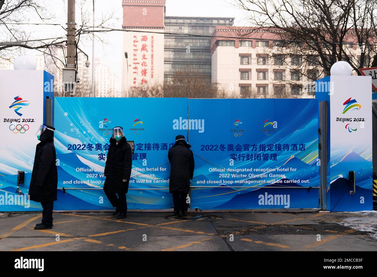 A security guard closes the gate after letting in an Olympic shuttle ...