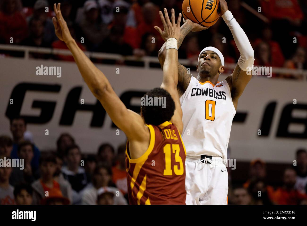 Oklahoma State's Avery Anderson III (0) shoots over Iowa State's Jaren Holmes (13) in the first ...