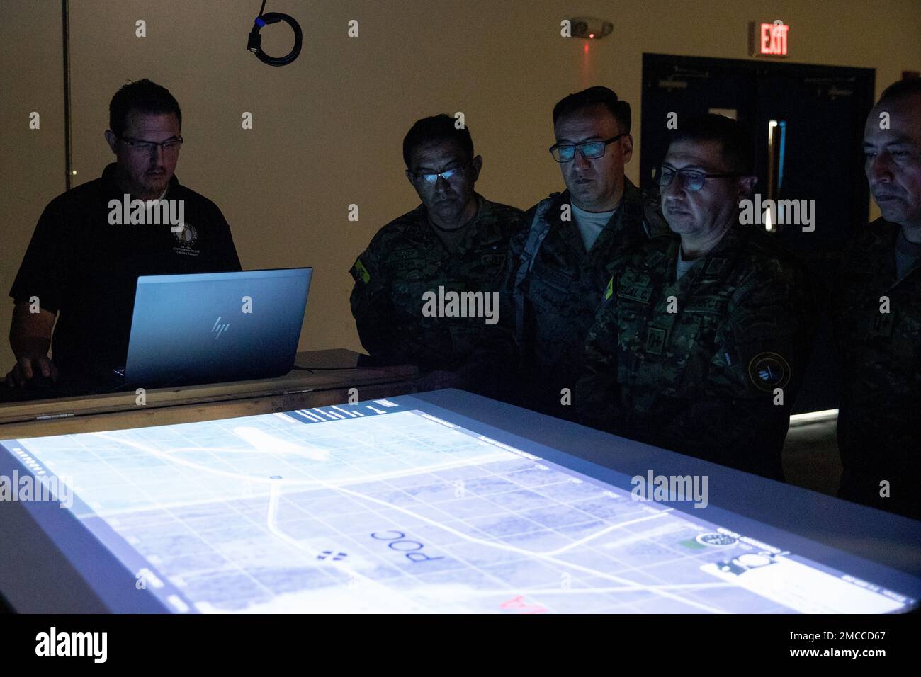 Army National Guard contractor Frank Peak demonstrates how their ...