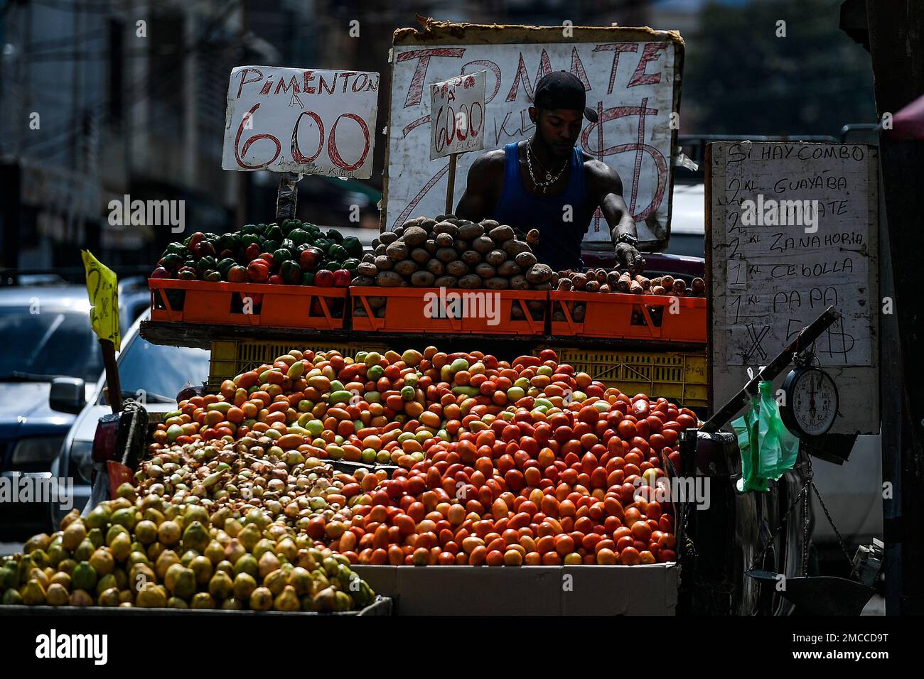 A street vendor sells fruit and vegetables from a truck in the Catia ...