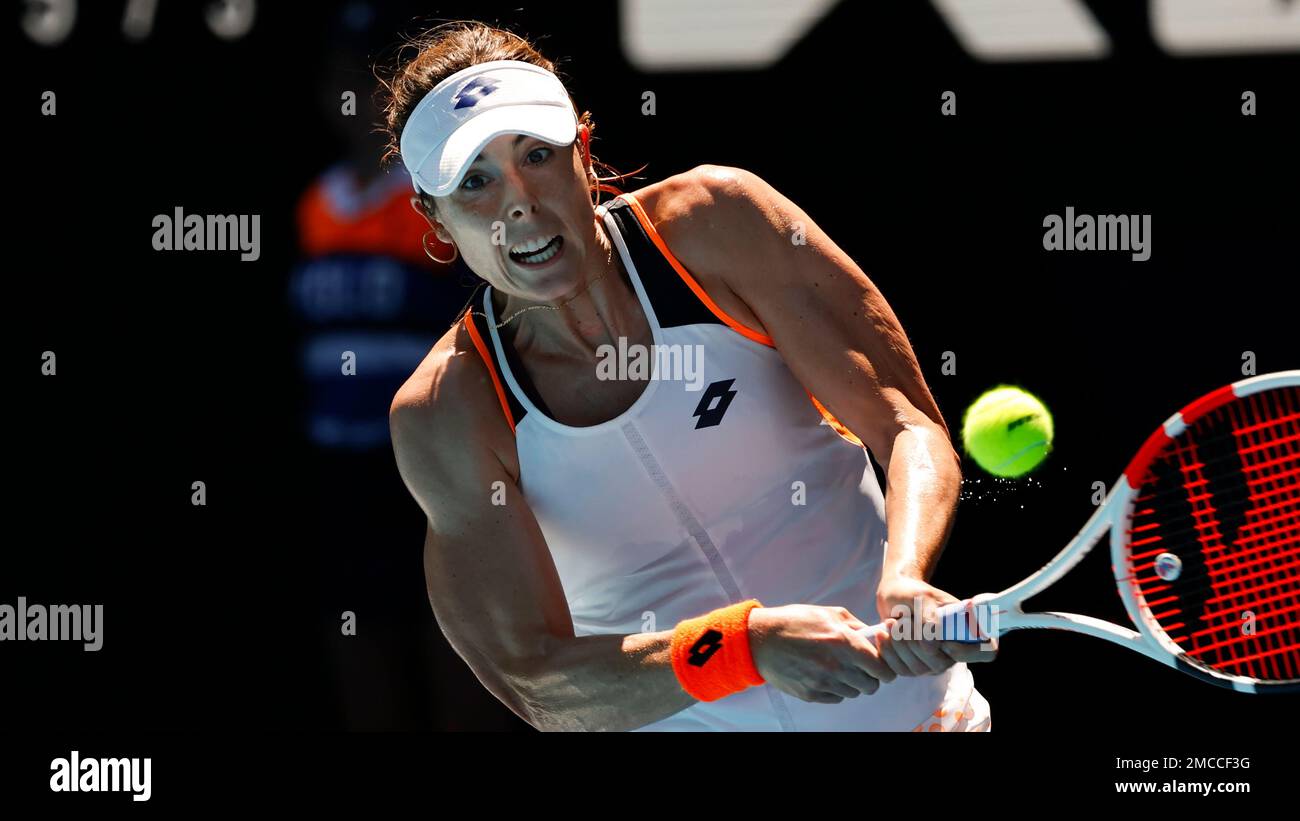 Alize Cornet of France makes a backhand return to Simona Halep of ...