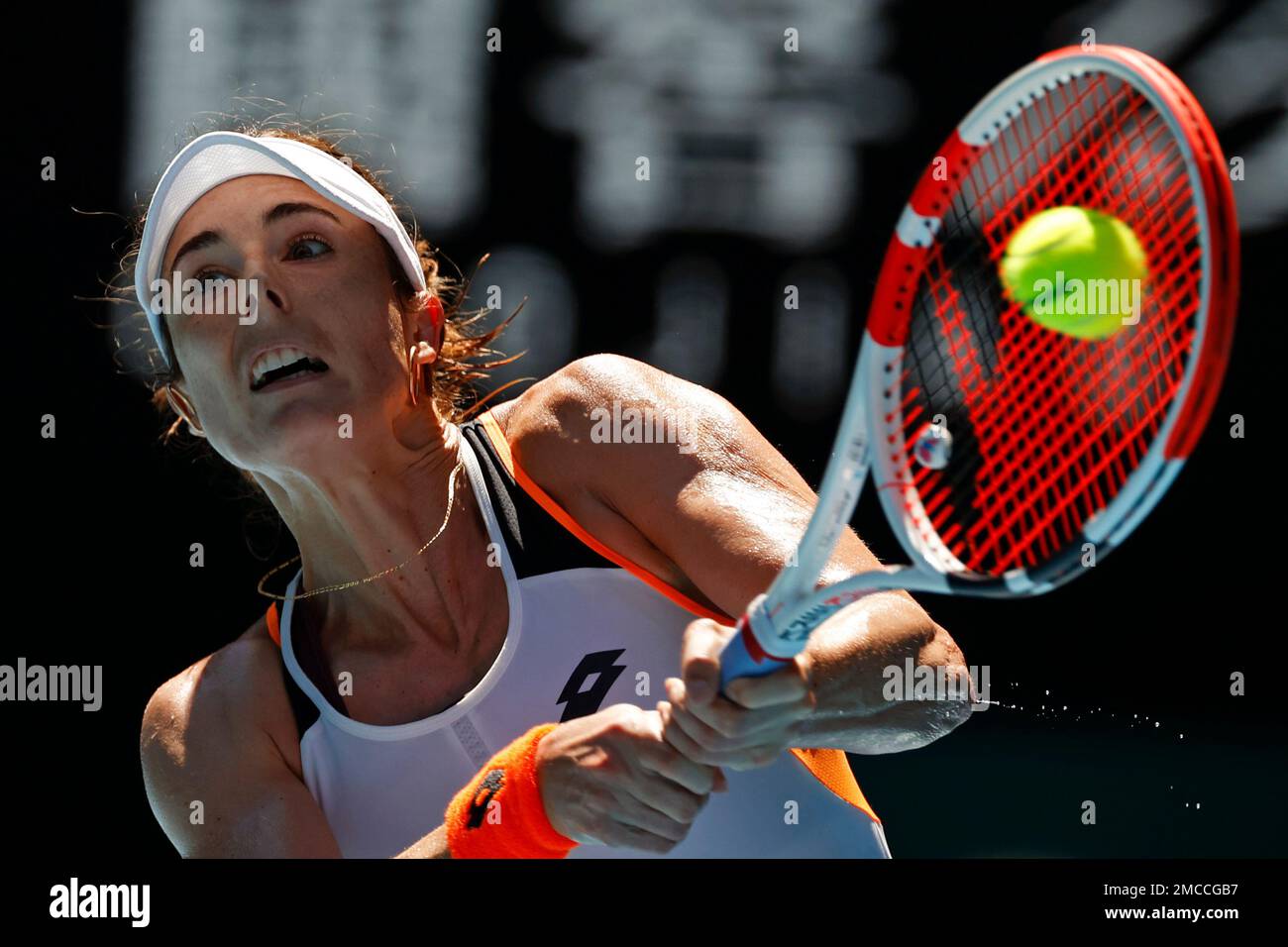 Alize Cornet of France makes a backhand return to Simona Halep of ...