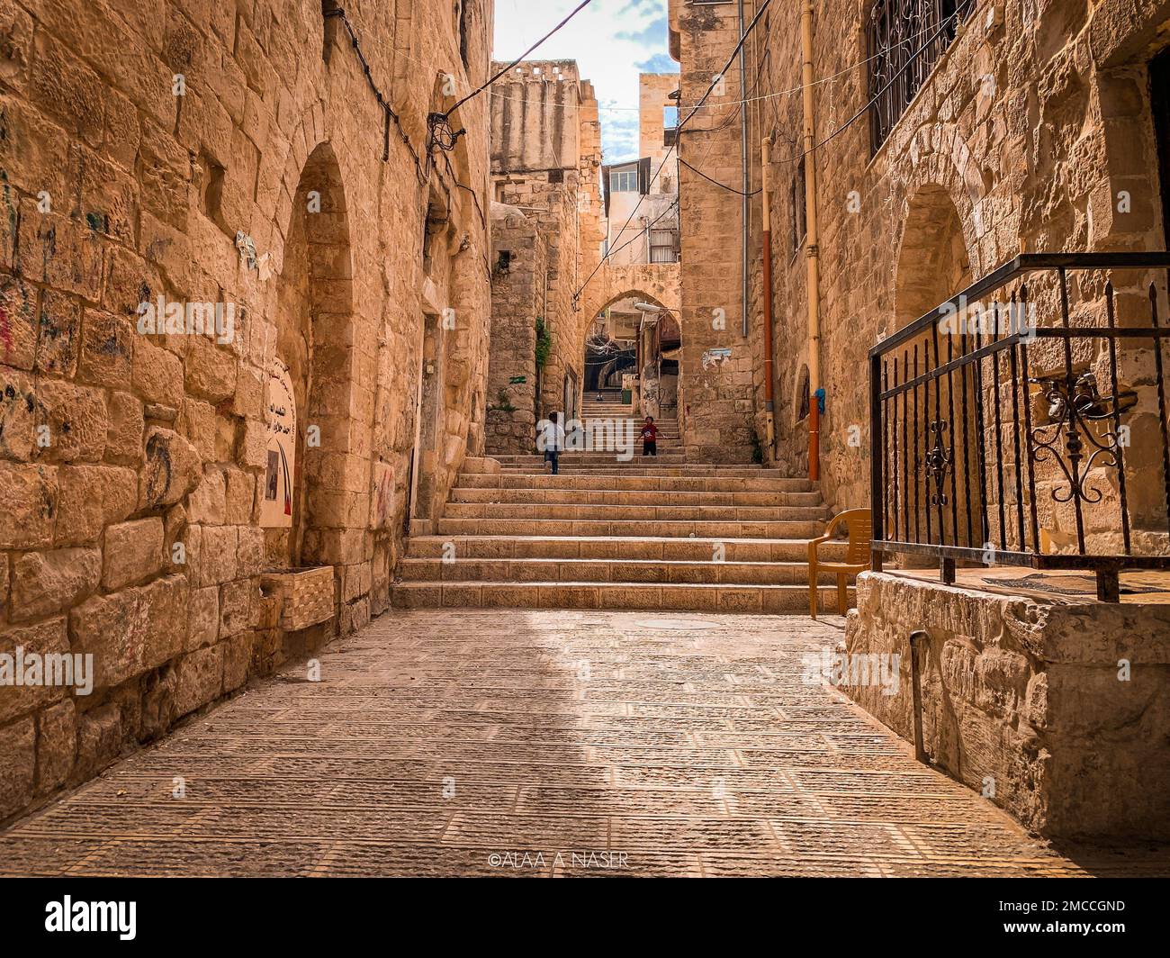 A view of a street and old stone wall buildings in Nablus, Palestine ...