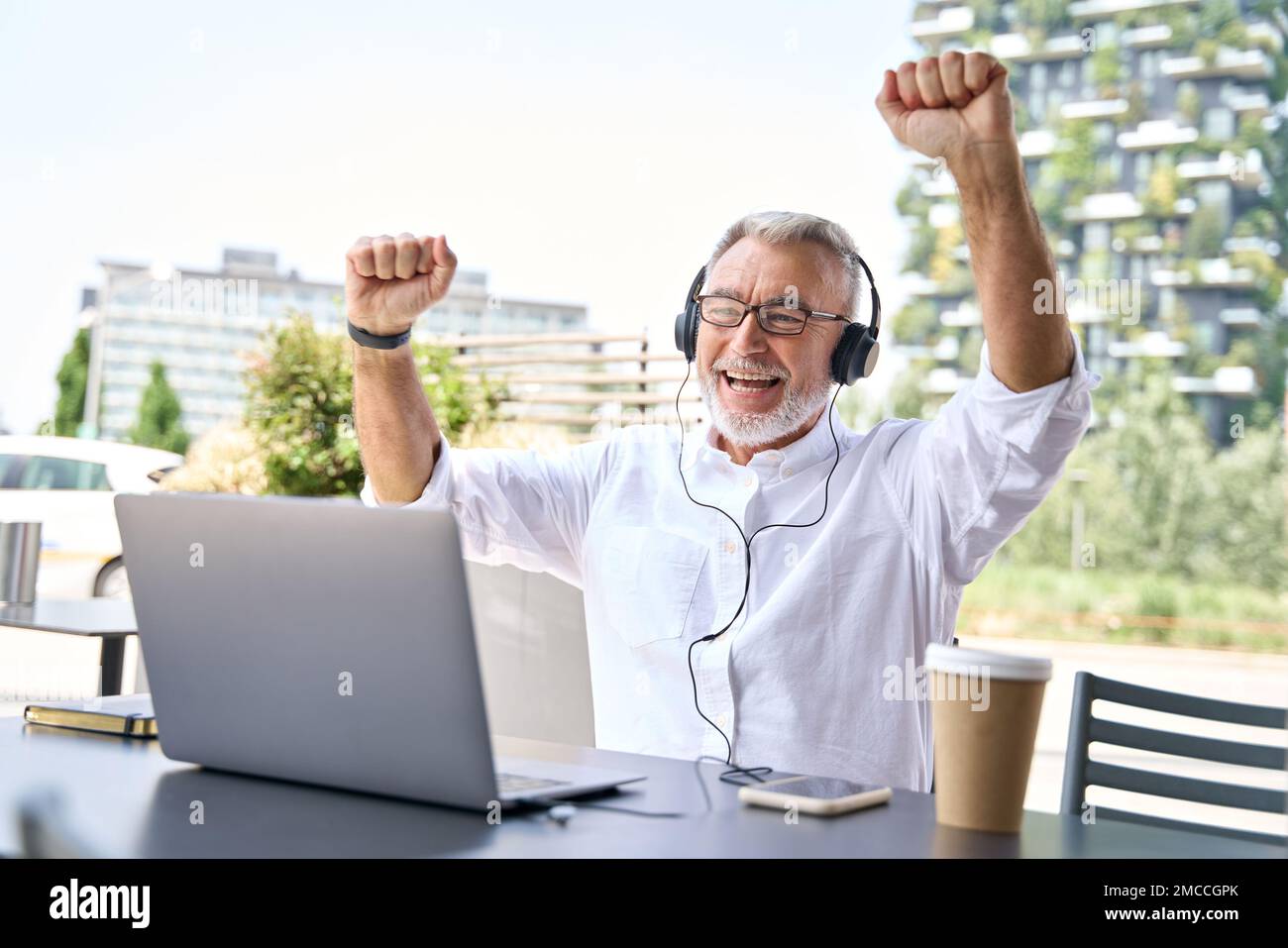 Excited older business man looking at laptop raising fists winning ...