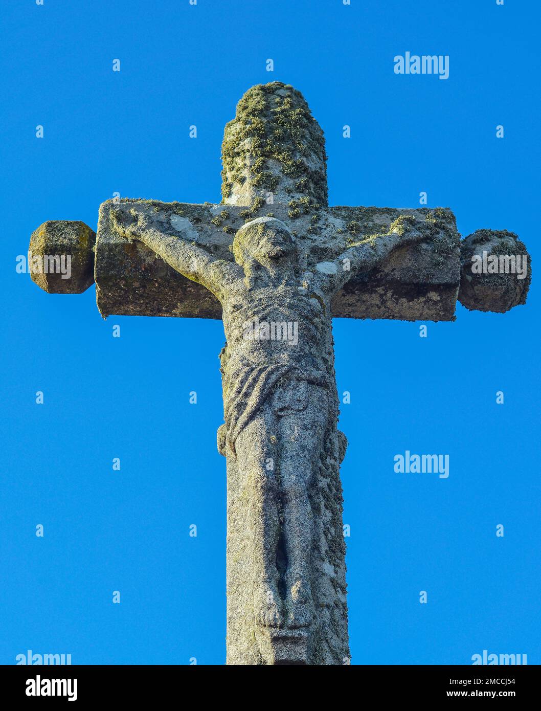 Stone cross with crucified Jesus Christ Stock Photo - Alamy