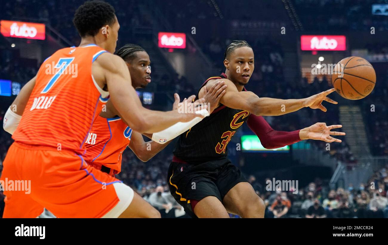 Cleveland Cavaliers' Isaac Okoro, right, passes against Oklahoma City ...