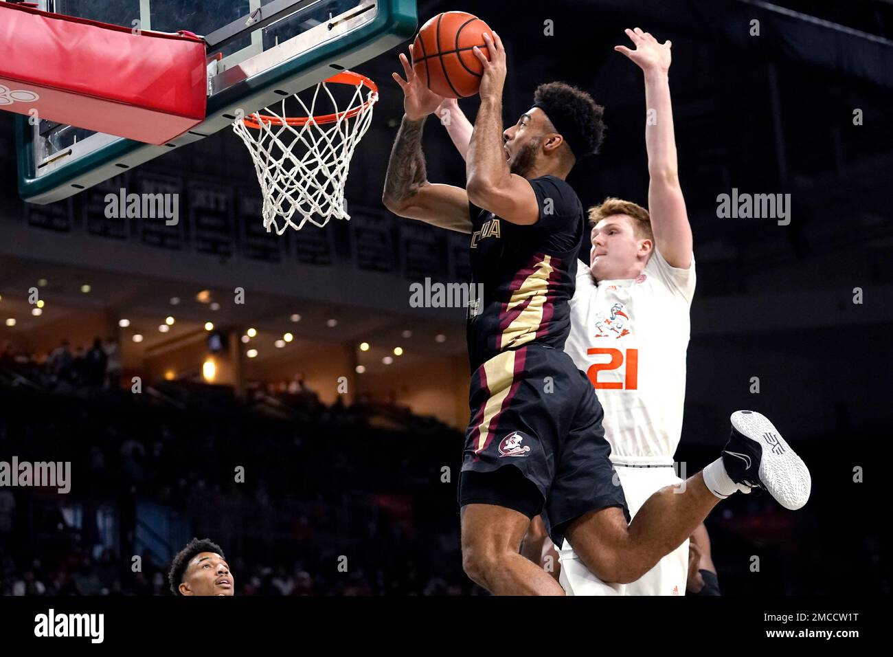Florida State guard Anthony Polite, left, shoots over Miami forward Sam ...