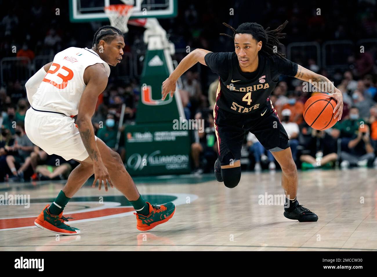 Florida State guard Caleb Mills (4) drives to the basket as Miami guard ...