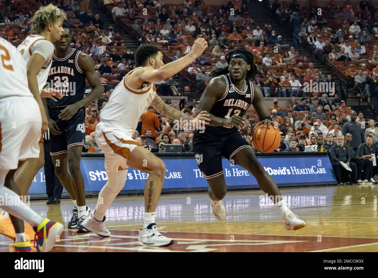Oklahoma State guard Issac Likekele, right, drives the ball against ...