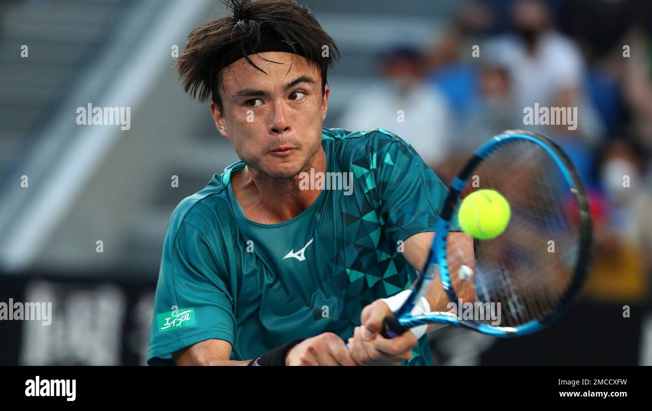 Taro Daniel of Japan plays a backhand return to Jannik Sinner of Italy ...