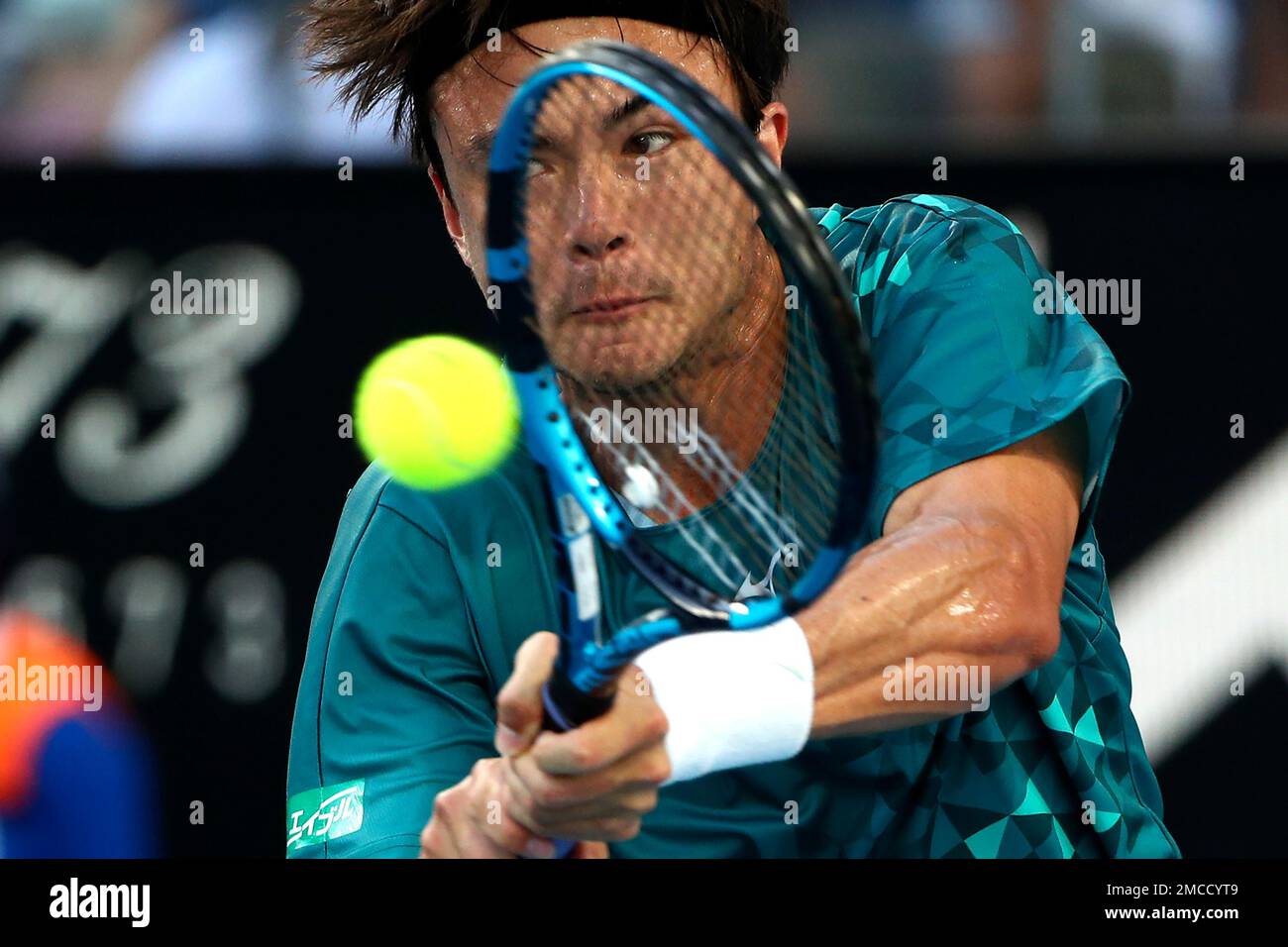 Taro Daniel of Japan plays a backhand return to Jannik Sinner of Italy ...