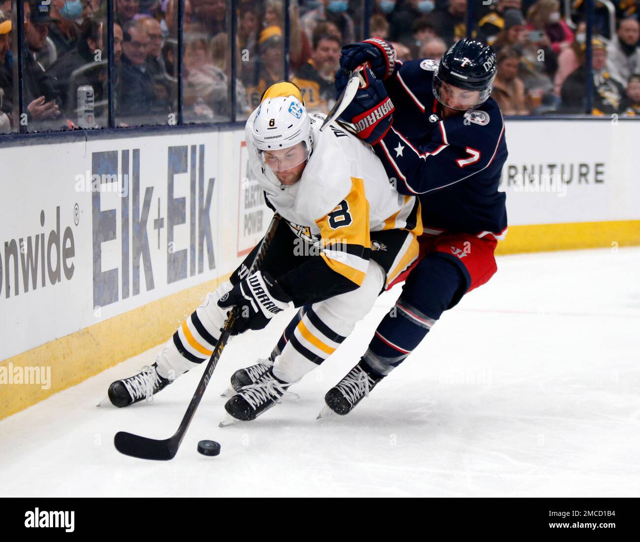 Pittsburgh Penguins defenseman Brian Dumoulin, left, controls the puck ...