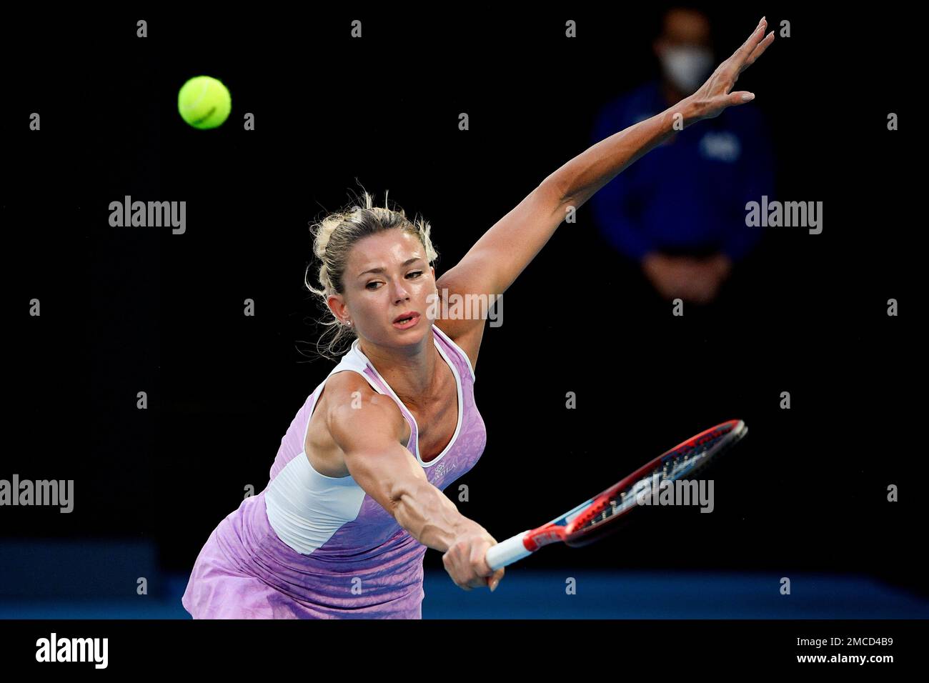 Camila Giorgi of Italy plays a backhand return to Ash Barty of Australia during their third ...
