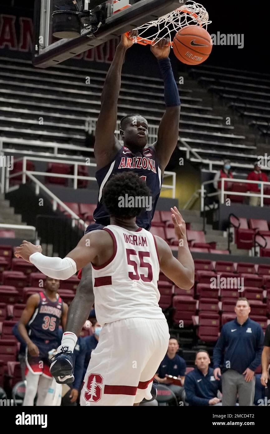 Arizona center Oumar Ballo, top, dunks above Stanford forward Harrison ...