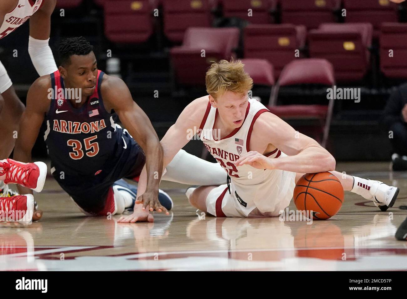 Stanford forward James Keefe, right, reaches for the ball next to ...