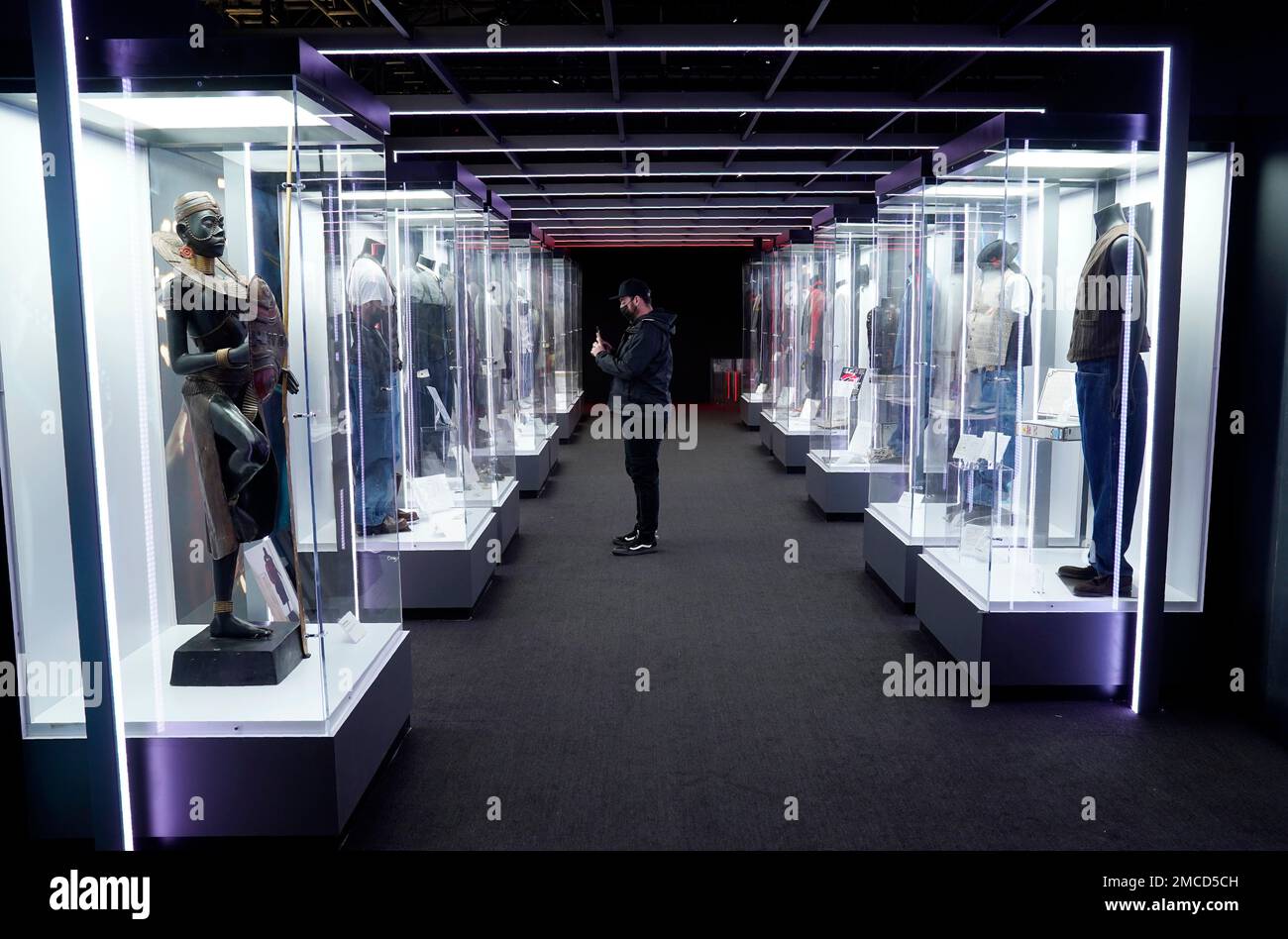 A visitor takes a cell phone photo of a display of artifacts from the ...