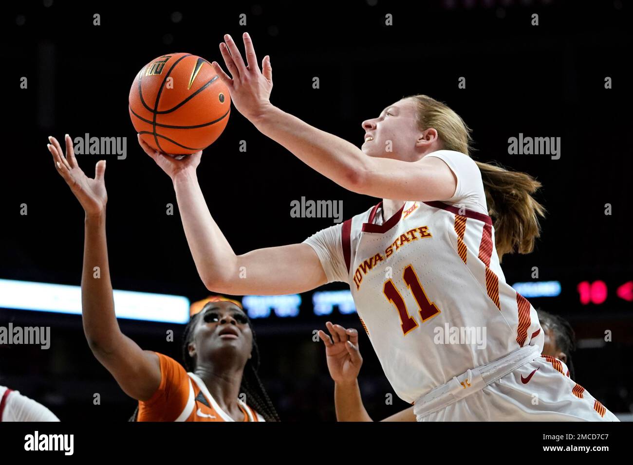Iowa State guard Emily Ryan (11) drives to the basket ahead of Texas ...