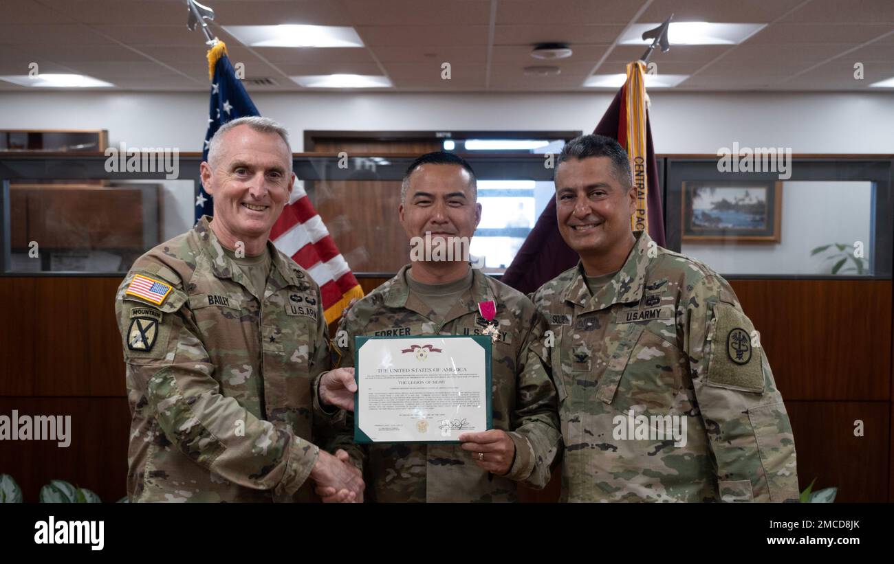 (pictured center) Command Sgt. Maj. Anthony Forker Jr. receives Legion of Merit award from (far ...