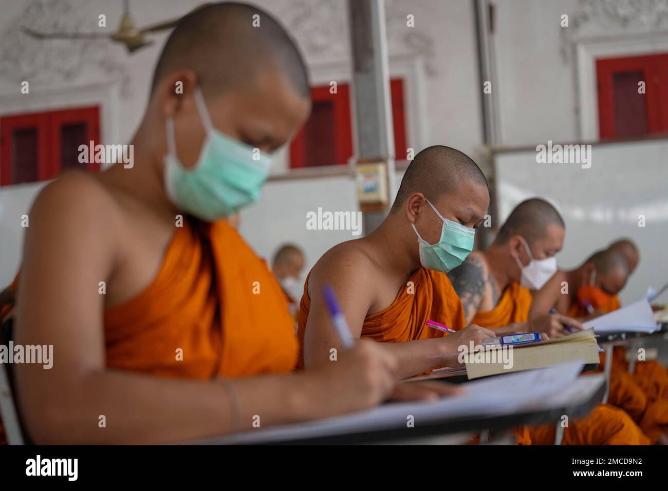 Buddhist monks wearing face masks to help protect themselves from the ...