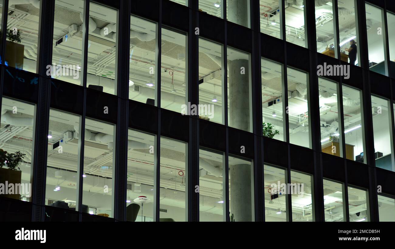 Modern office building in city at the night. View on illuminated ...