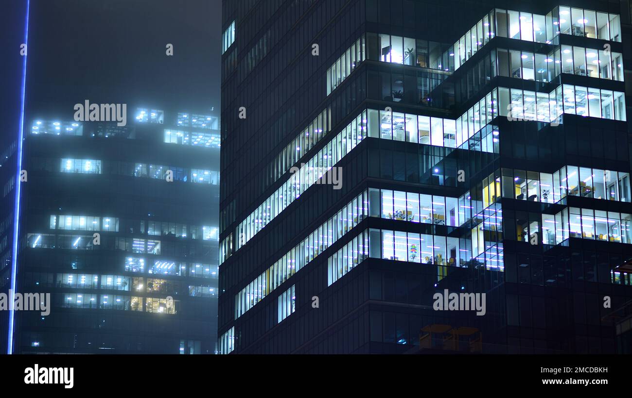 Modern office building in city at the night. View on illuminated ...