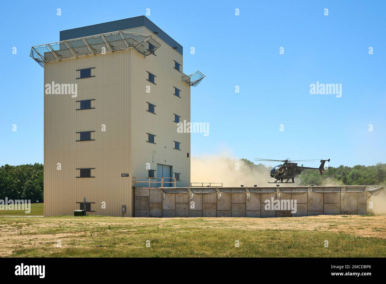 A MH-6M Little Bird helicopter lands on the Multi-Use Helicopter ...
