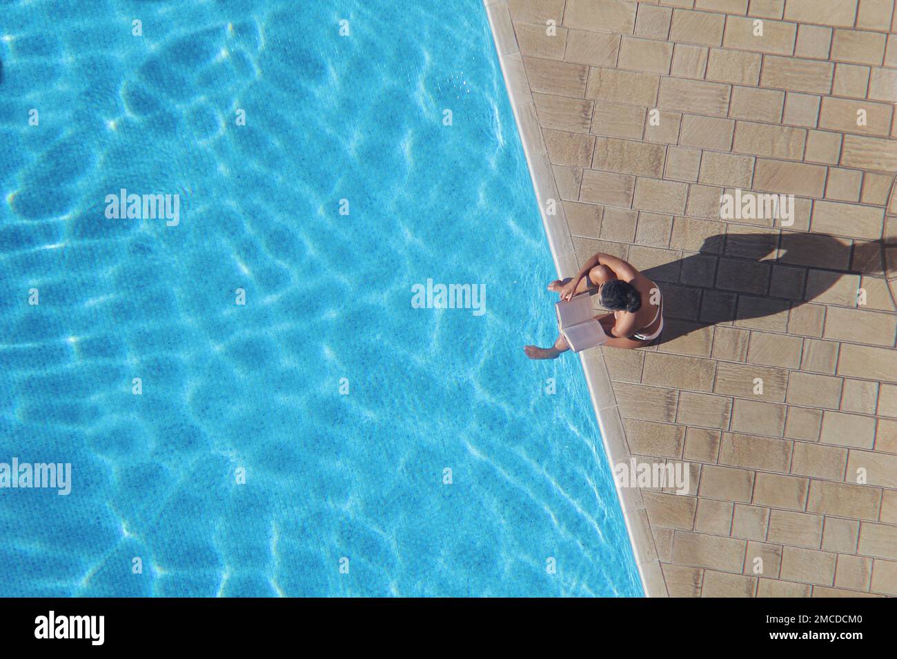 Beautiful young woman sunbathing poolside hi-res stock photography and ...