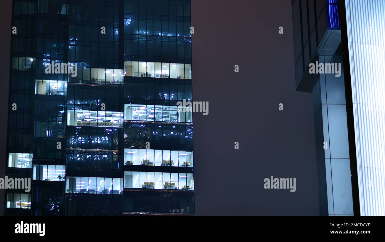 Modern office building in city at the night. View on illuminated ...