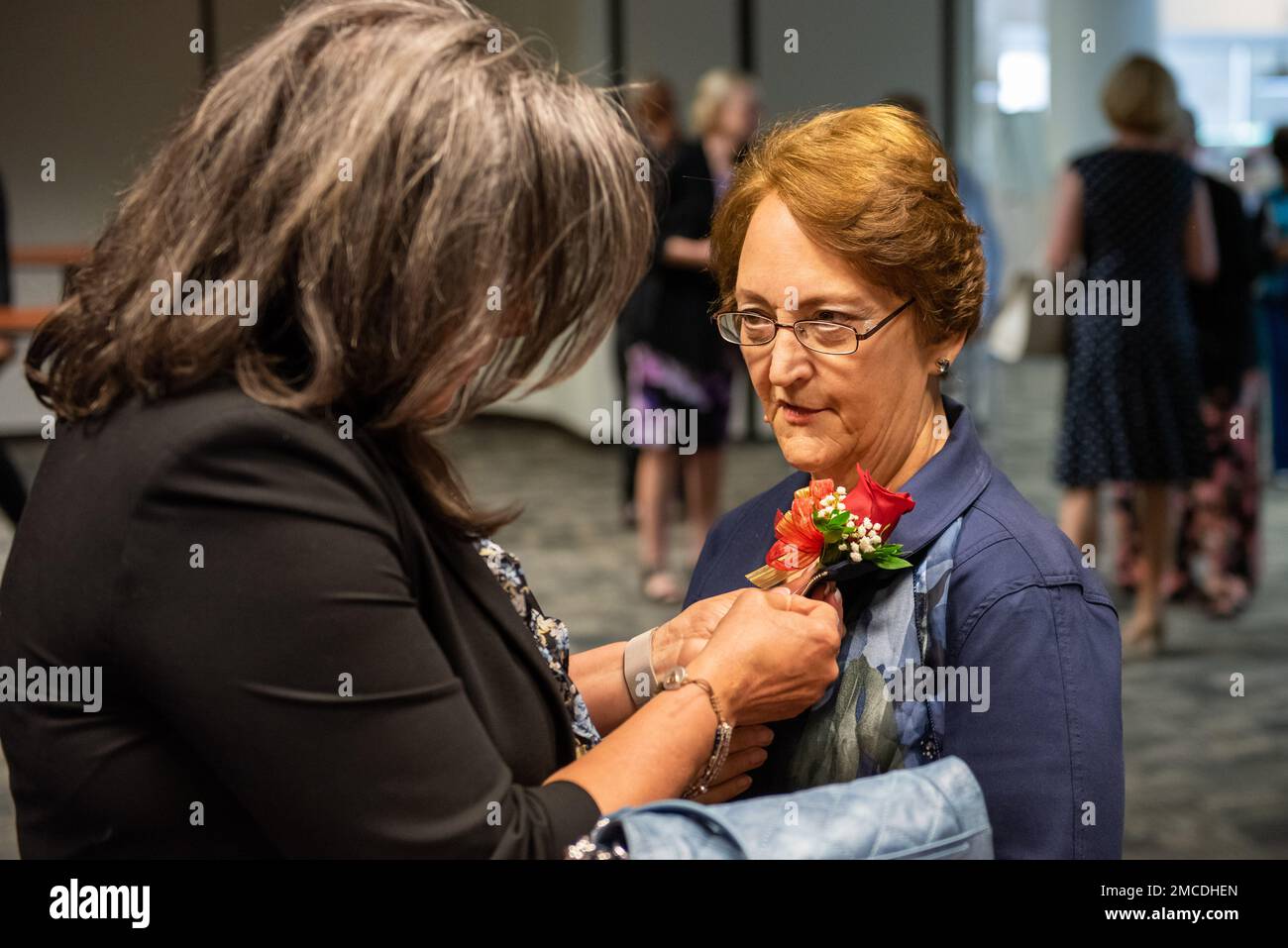 2020 inductee Marty Sass gets her boutineer adjusted by a friend. Prior ...