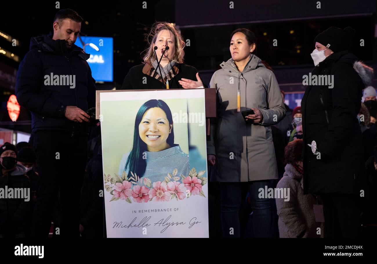 Friends of Michelle Alyssa Go speak during a candlelight vigil at Times ...