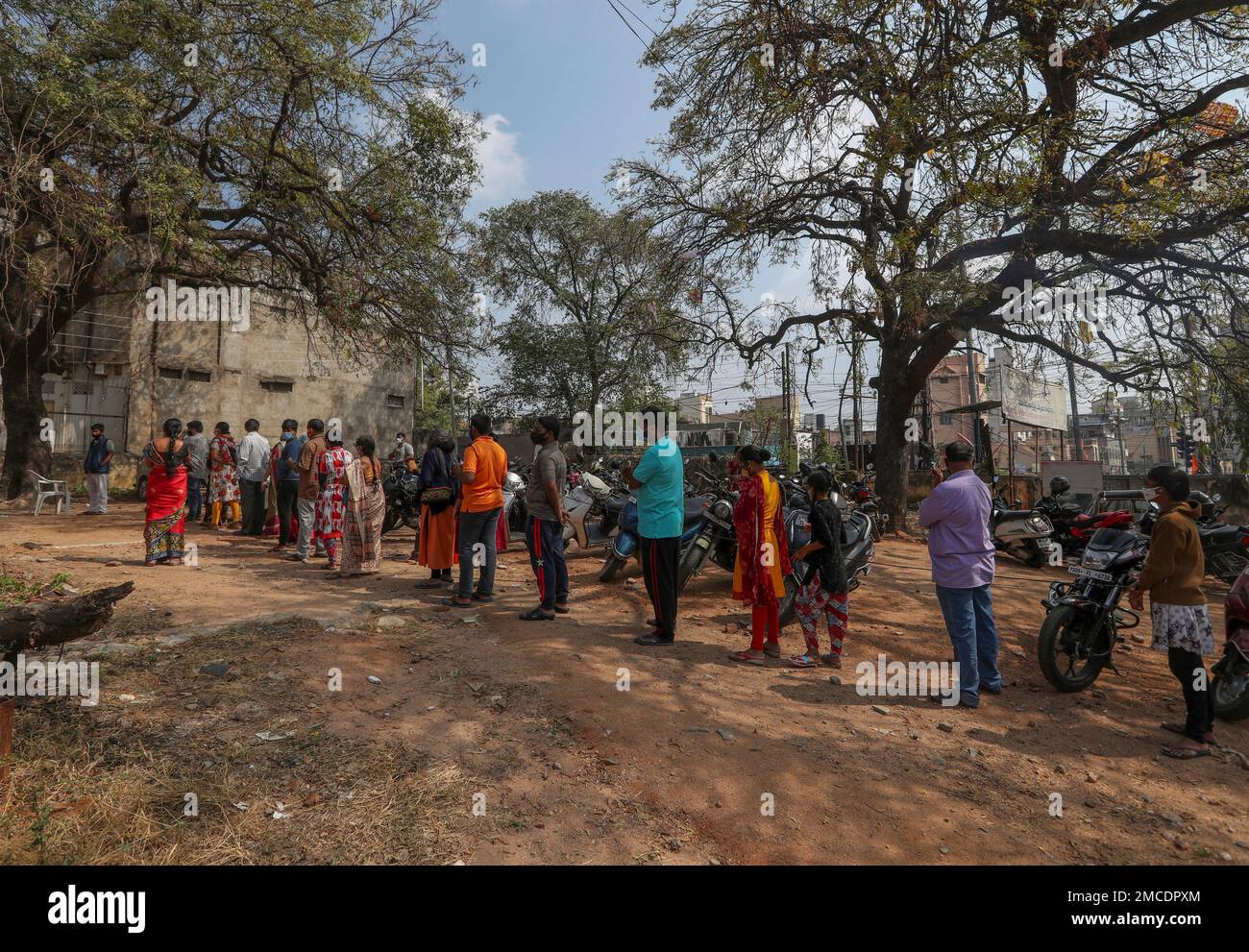 People line up to give their swab samples to test for COVID-19 at a ...