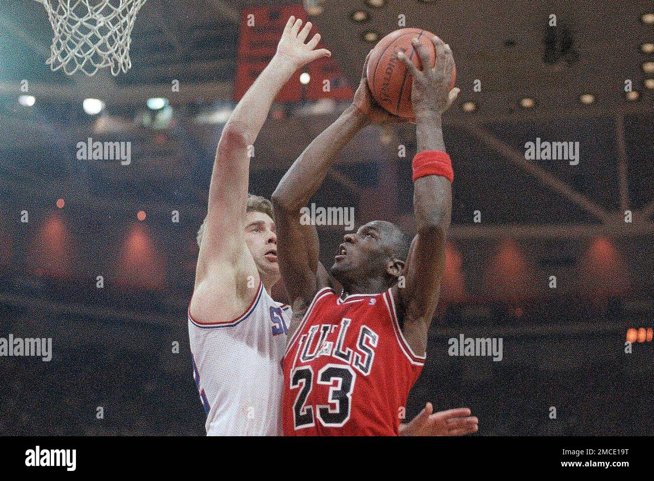 FILE - Chicago Bulls' Michael Jordan, right, goes to the hoop next to ...