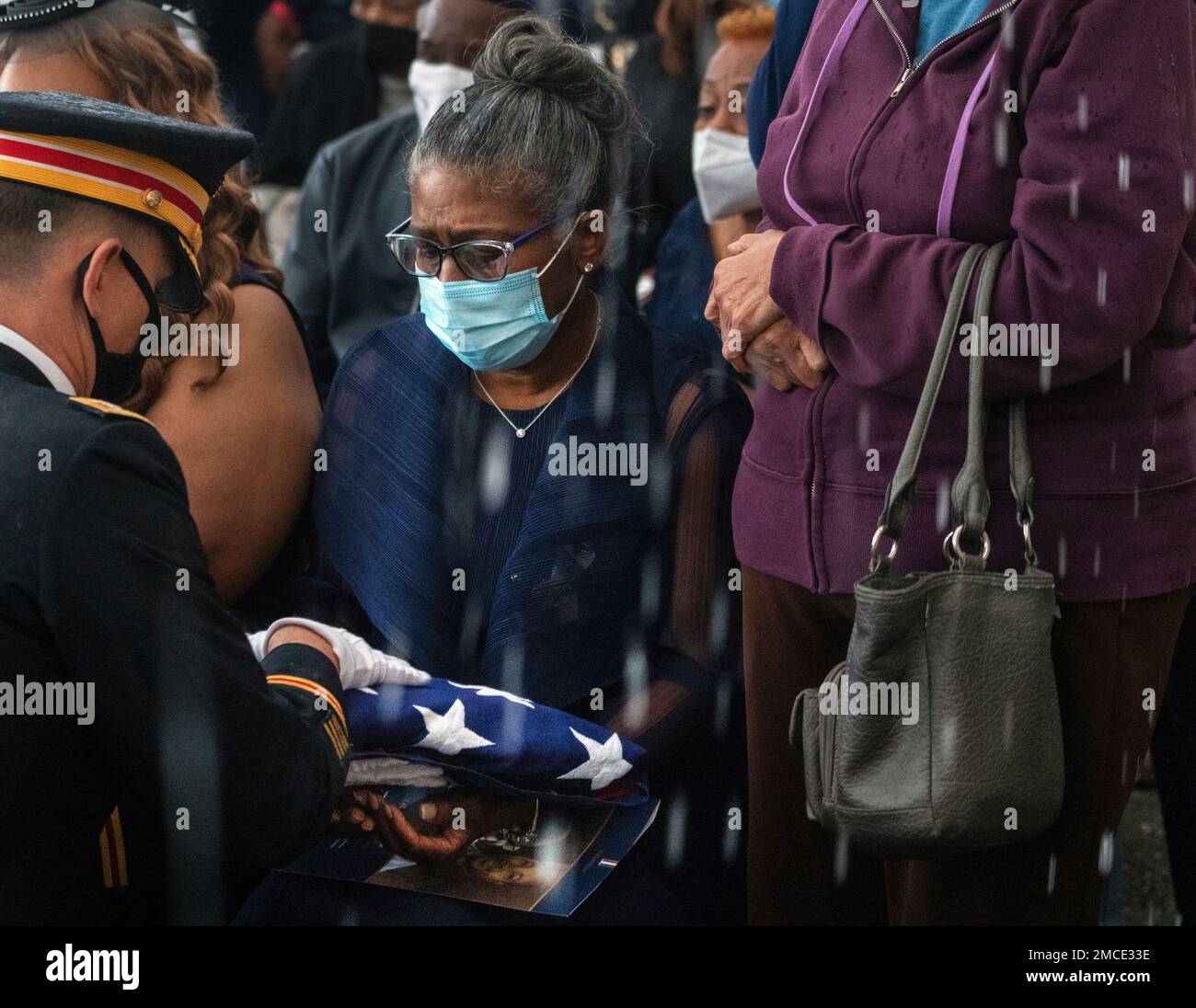 Vanessa Brooks receives the American flag from the coffin of her father ...