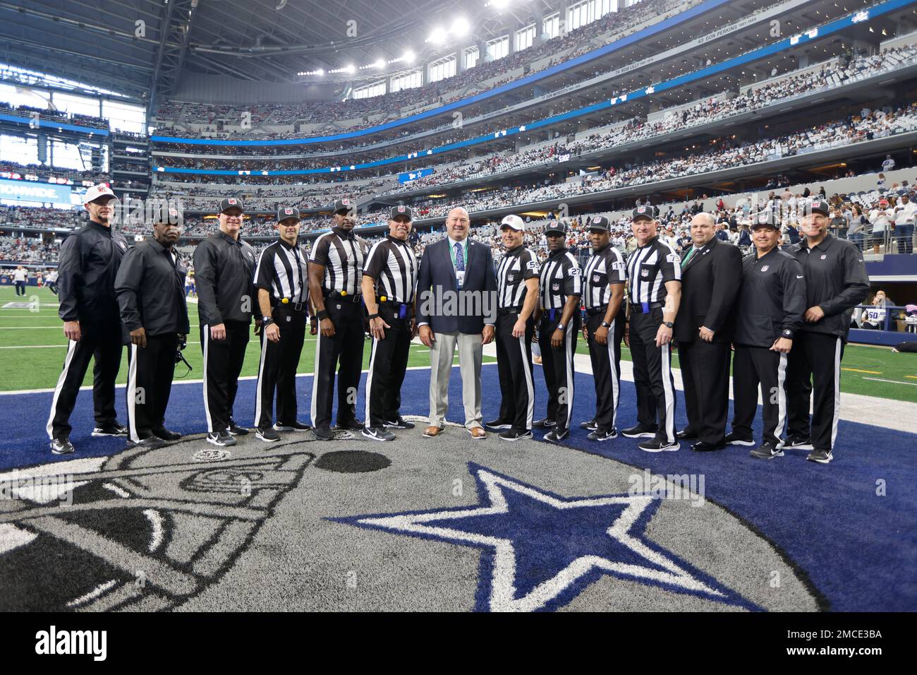 The NFL officials crew poses for photos on the field at AT&T Stadium ...