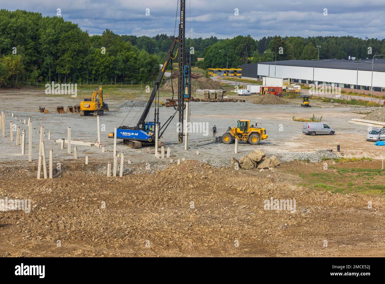 Industrial view of construction site with machinery and pile driving ...