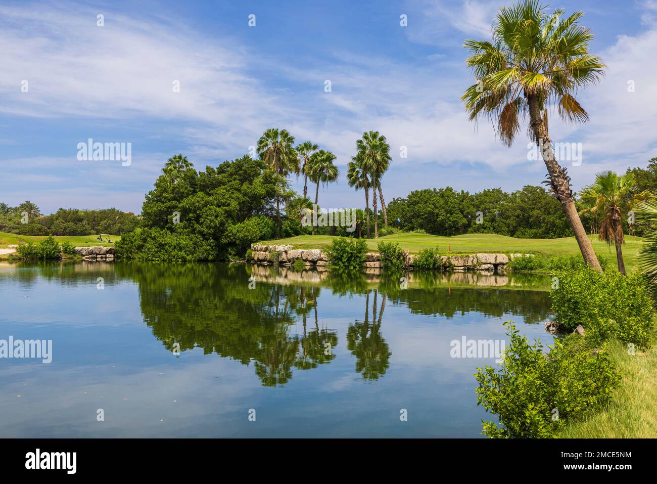 Beautiful view of blue water surface of pond with golf courses against ...