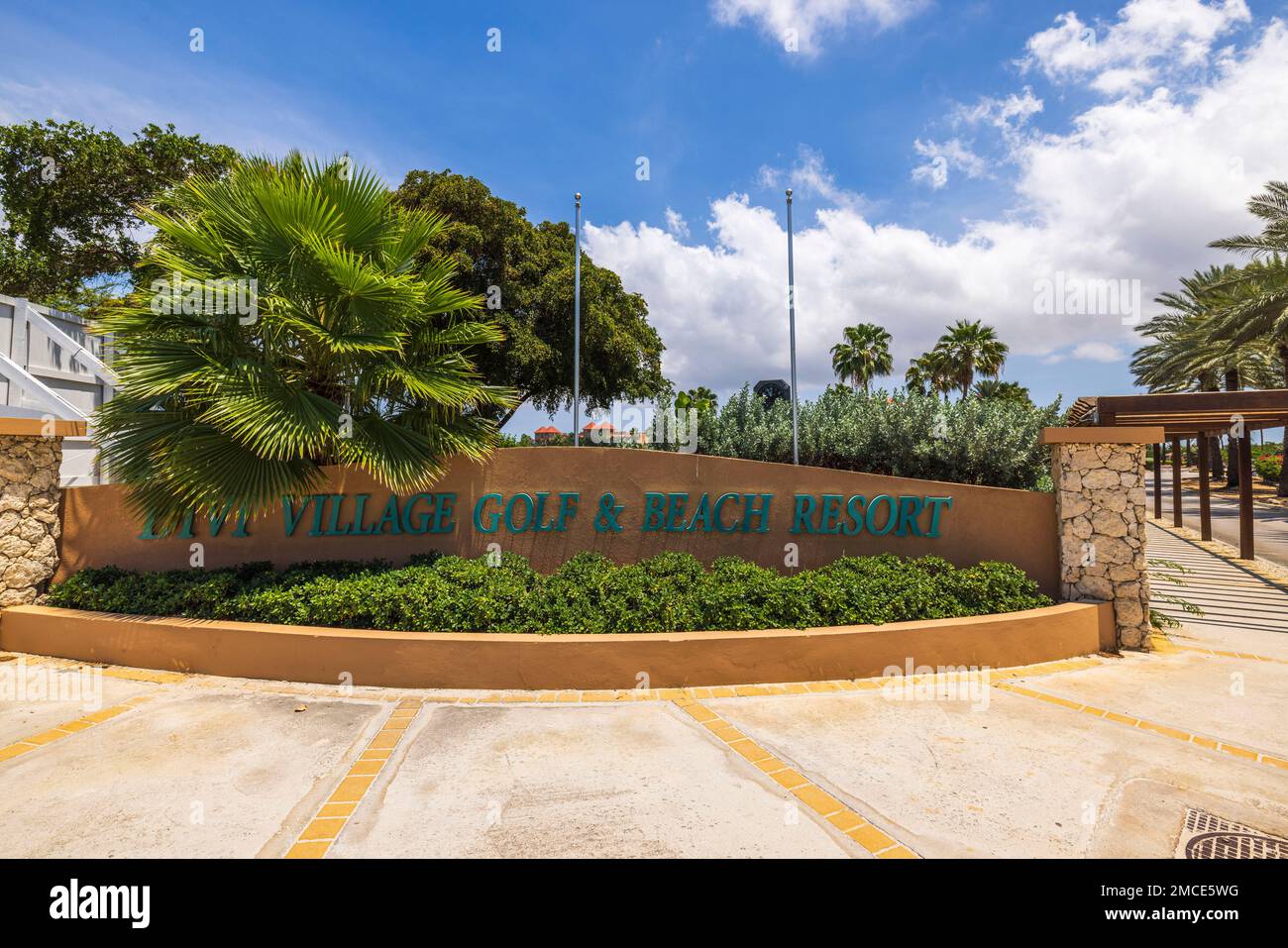 Beautiful view of hotel grounds with logo of Divi Village Golf Hotel ...