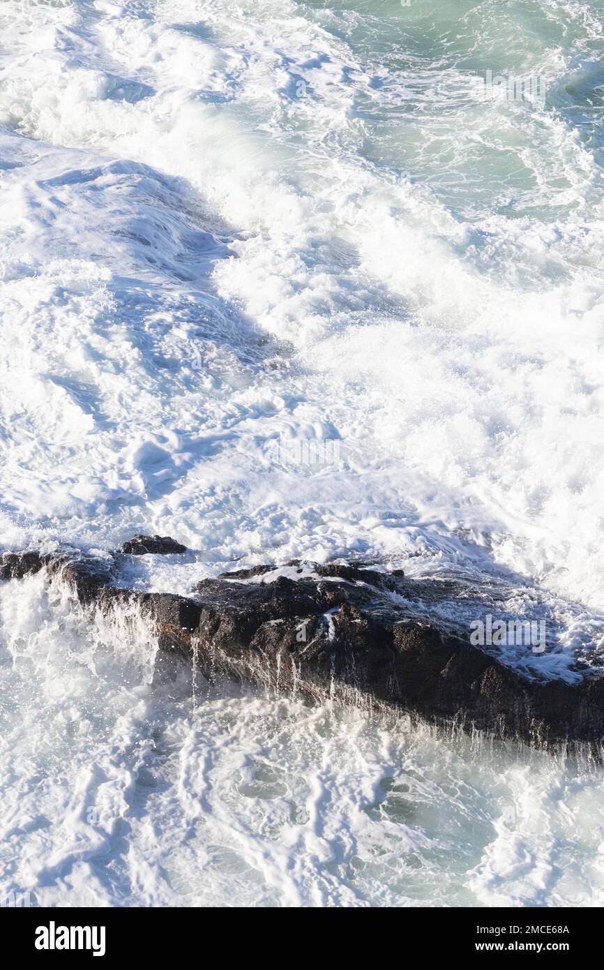 Aerial view of frothy ocean water during a winter storm with king tide ...