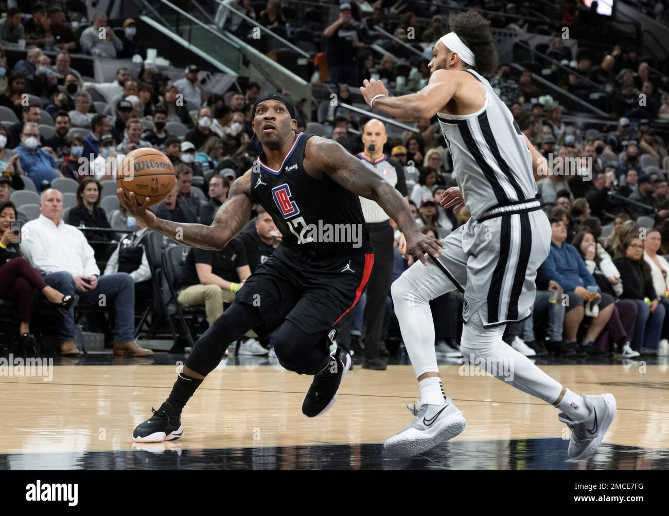 Los Angeles Clippers' Eric Bledsoe, left, drives against San Antonio Spurs' Derrick White during ...