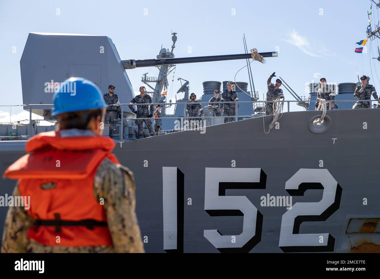 Personnel from Royal Australian Navy frigate HMAS Warramunga throw a ...
