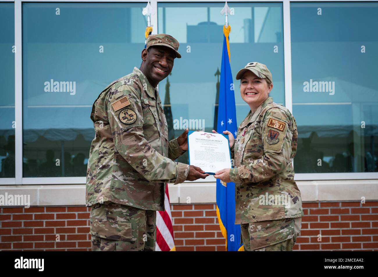 Col. Dolphis Hall, left, 4th Medical Group commander, presents the ...