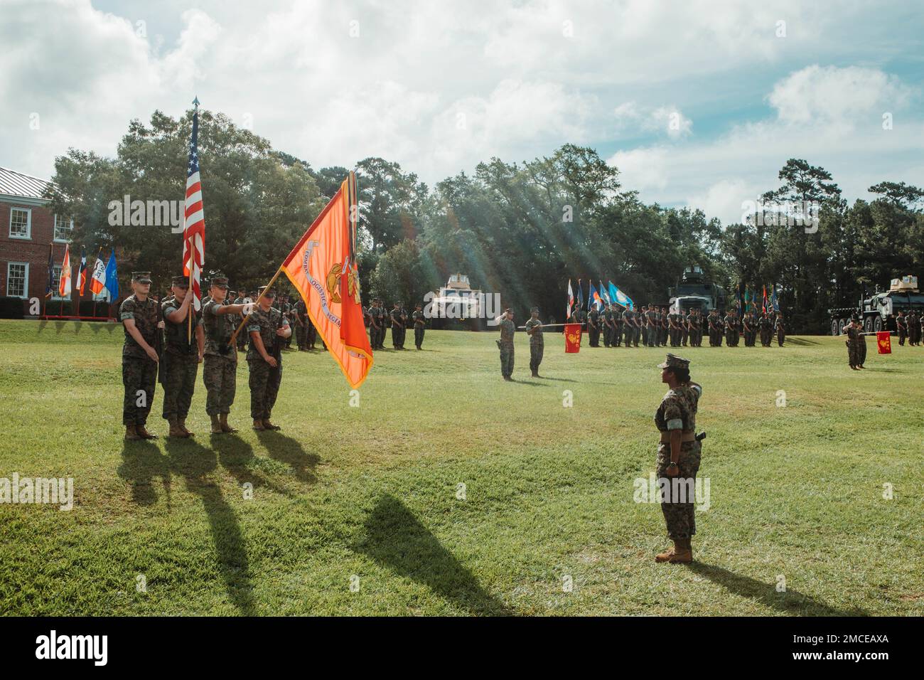 U.S. Marines with Combat Logistics Regiment 2 salute while standing in ...