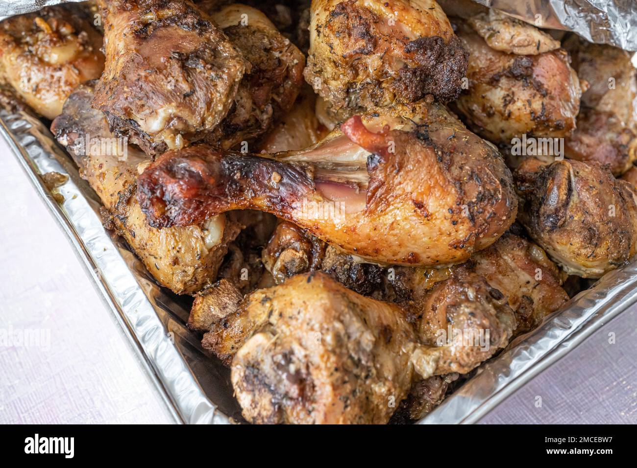 grilled chicken thighs ready to eat at a party Stock Photo - Alamy