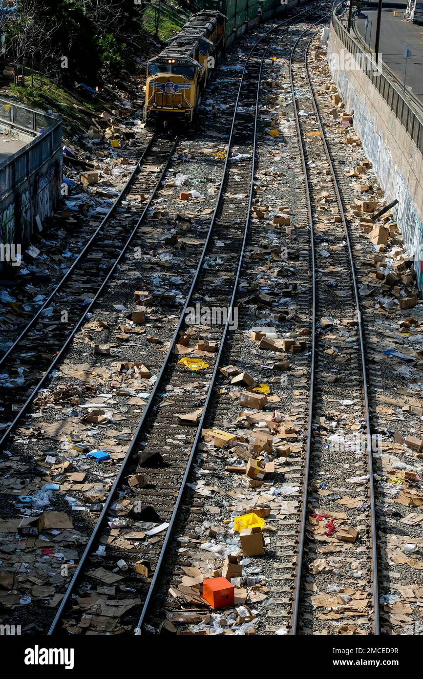 A train passes by as shredded boxes and packages are seen at a section ...